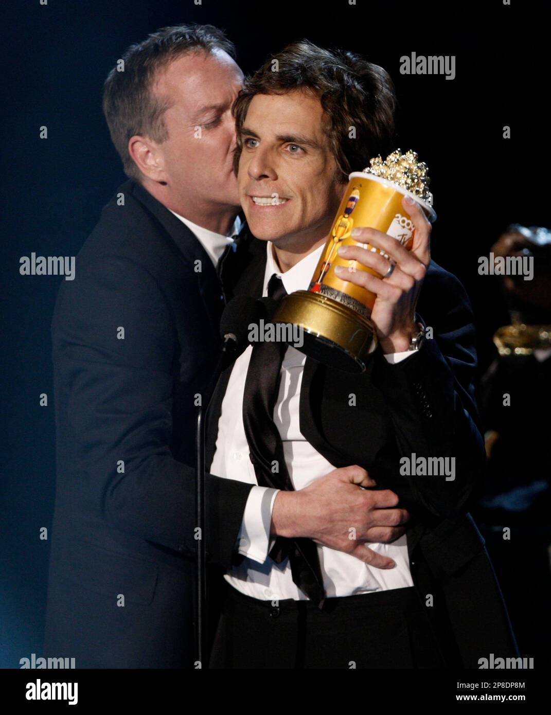 Keith Sutherland, left, kisses Ben Stiller as he accepts the MTV ...
