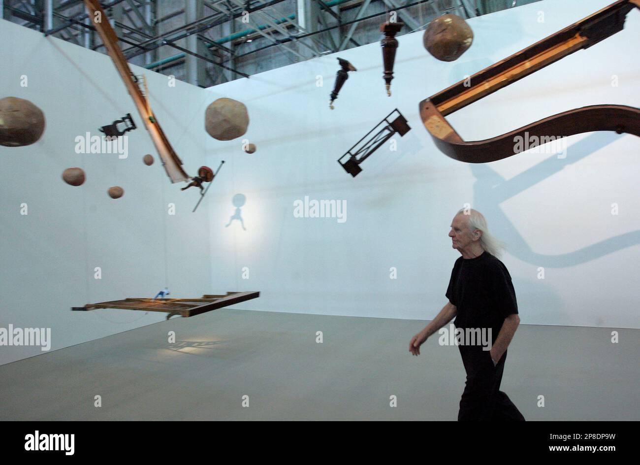 Ken Unsworth walks through a room that hold a dismantled grand piano as ...