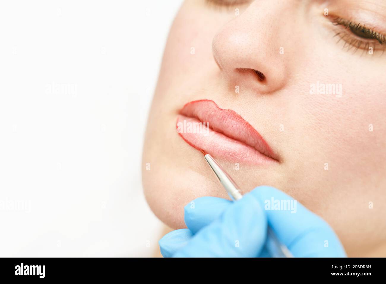 Permanent makeup. Beauty spa procedure. young woman. Face tattoo. Lip ...