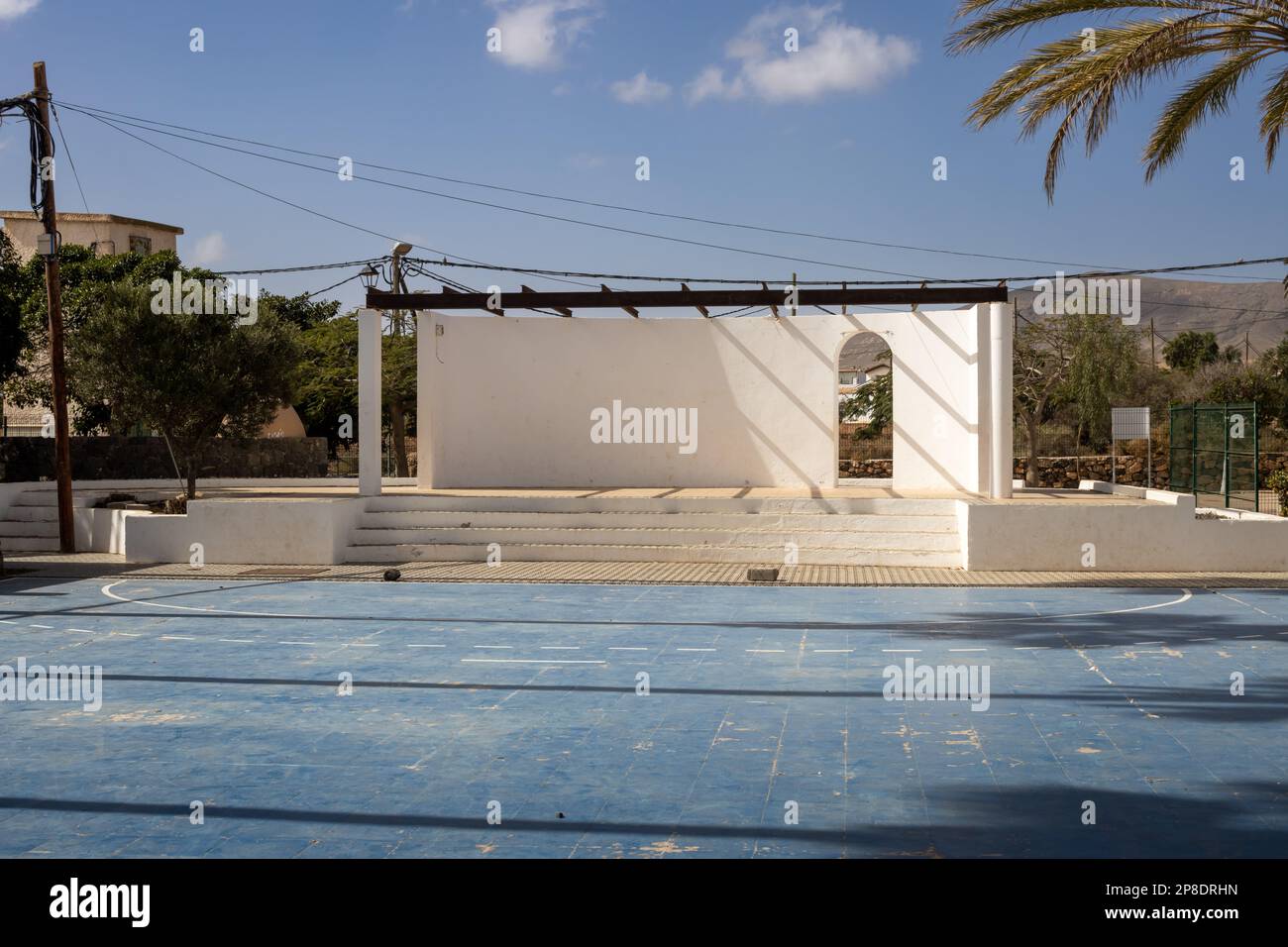 Blue playground of a school basketball stadium. White stage for the ...