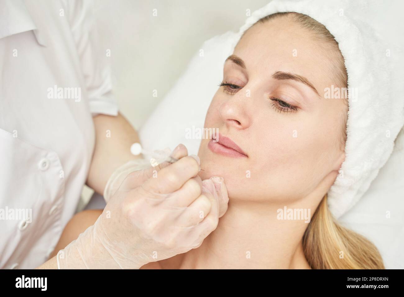 Injection at spa salon. Doctor hands in gloves. Closeup. Pretty female ...