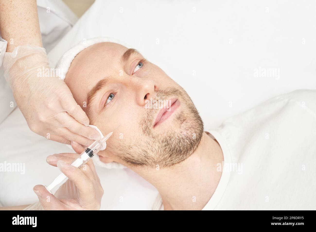 Injection at spa salon. Doctor hands in gloves. Closeup. Pretty male ...