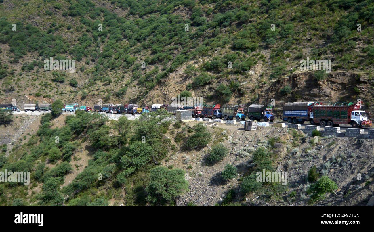 A convoy of trucks carrying relief goods head toward recently captured ...
