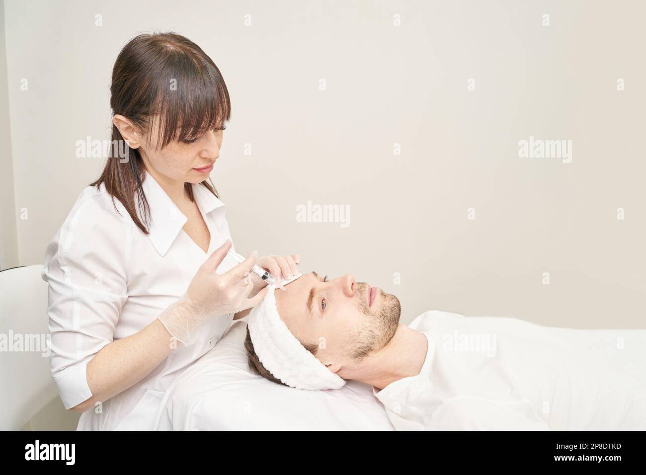 Injection at spa salon. Doctor hands in gloves. Closeup. Pretty male ...