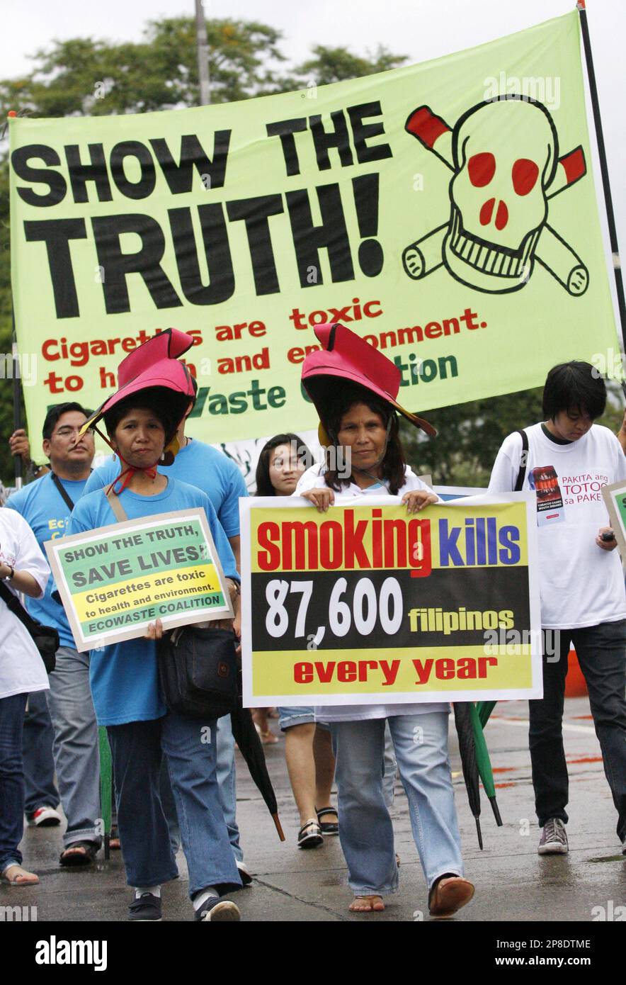 Marchers display streamers and placards showing the bad effect of ...