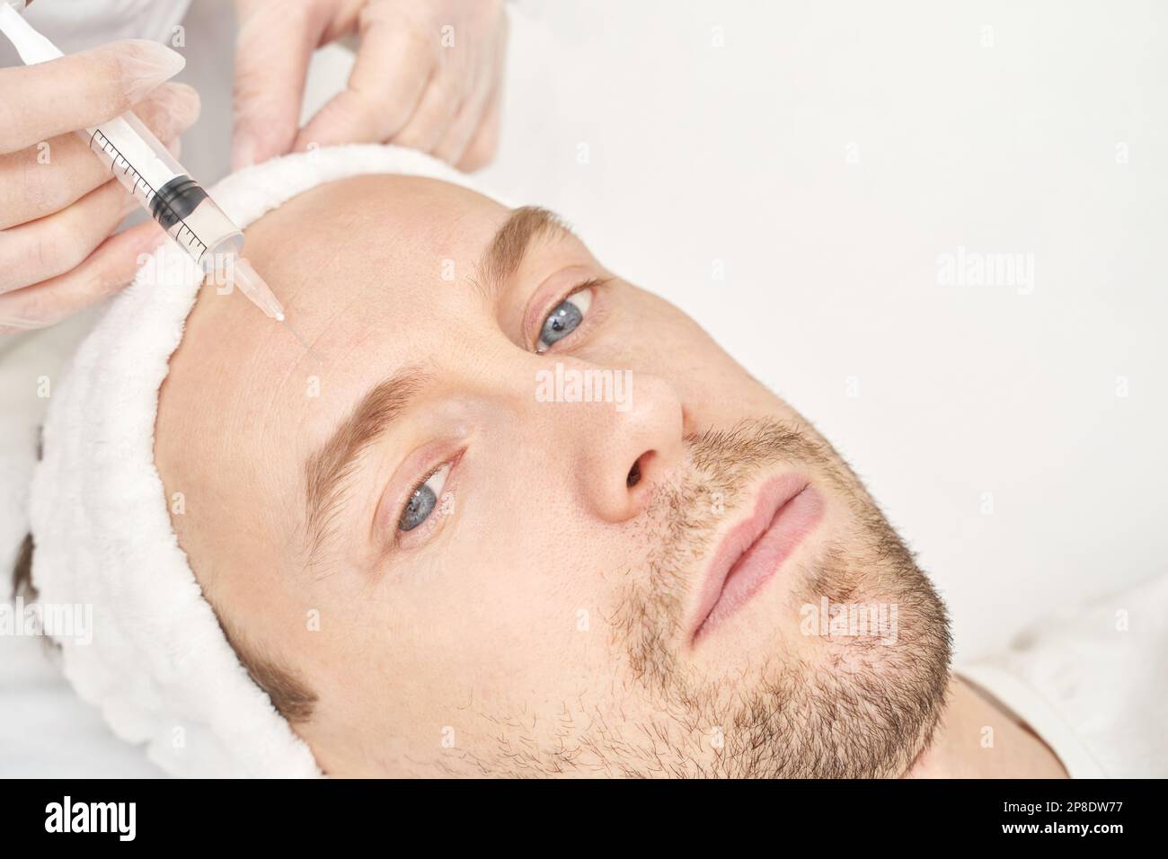 Injection at spa salon. Doctor hands in gloves. Closeup. Pretty male ...