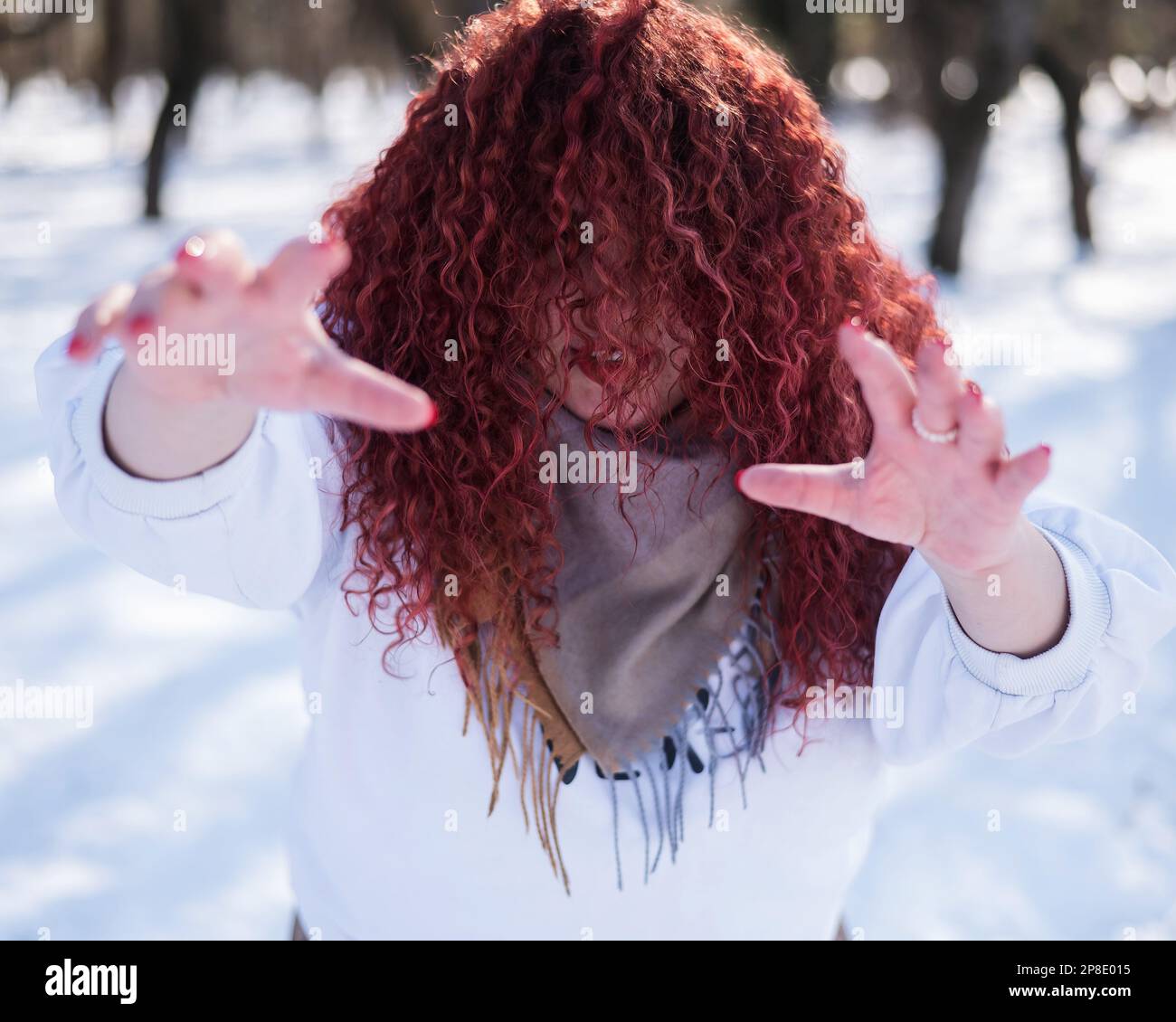 The plump-cheeked woman threw her red hair over her face and held out ...