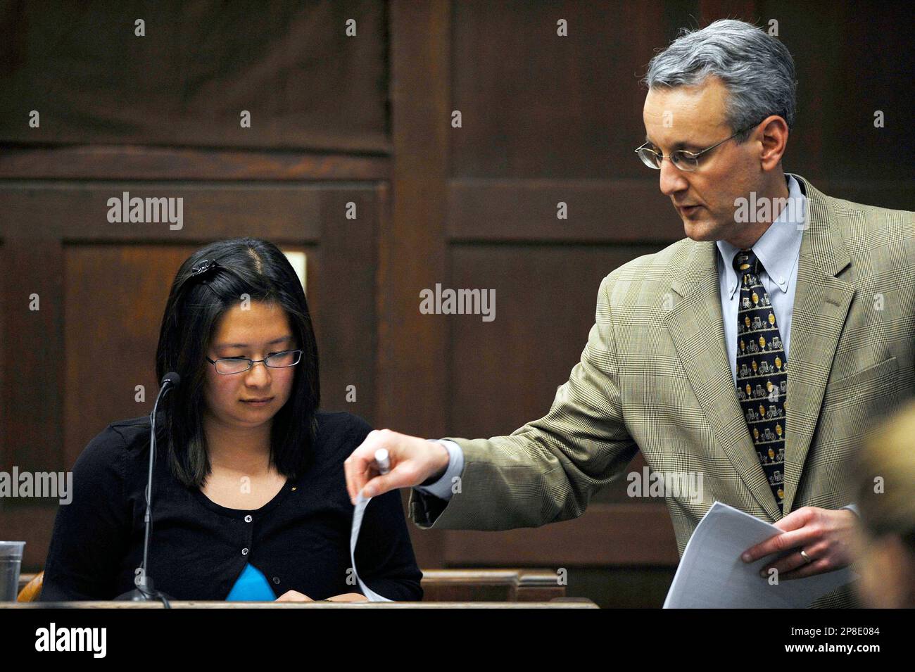 Witness Aileen Ang, left, is shown a copy of her cellular phone records ...