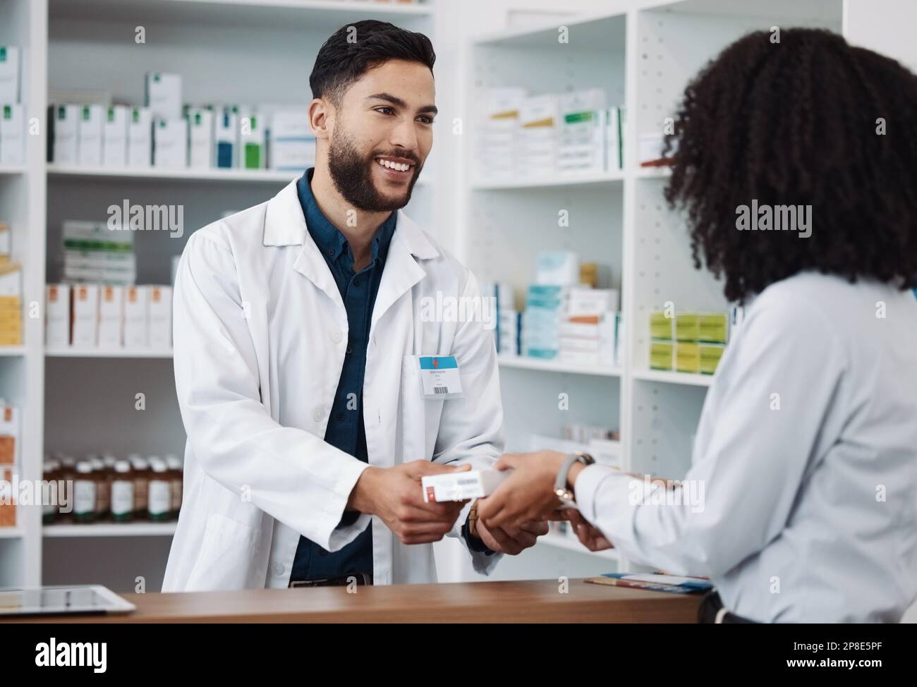 Man, pharmacist and medication consulting customer at counter for ...