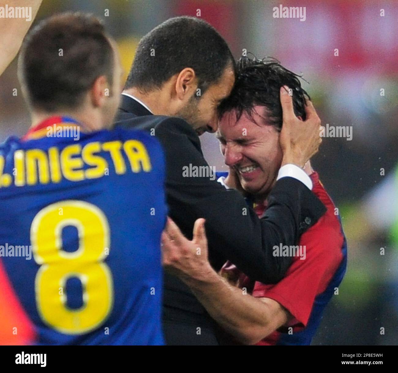 Barcelona coach Pep Guardiola, left, hugs Lionel Messi at the end of ...