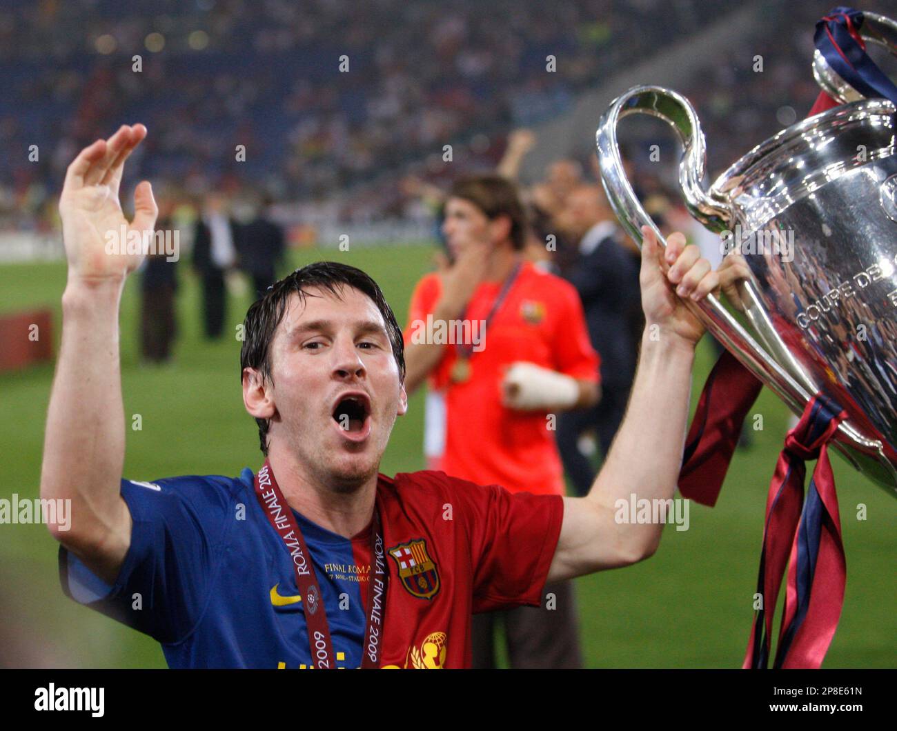 Barcelona's Lionel Messi holds the trophy at the end of the UEFA ...