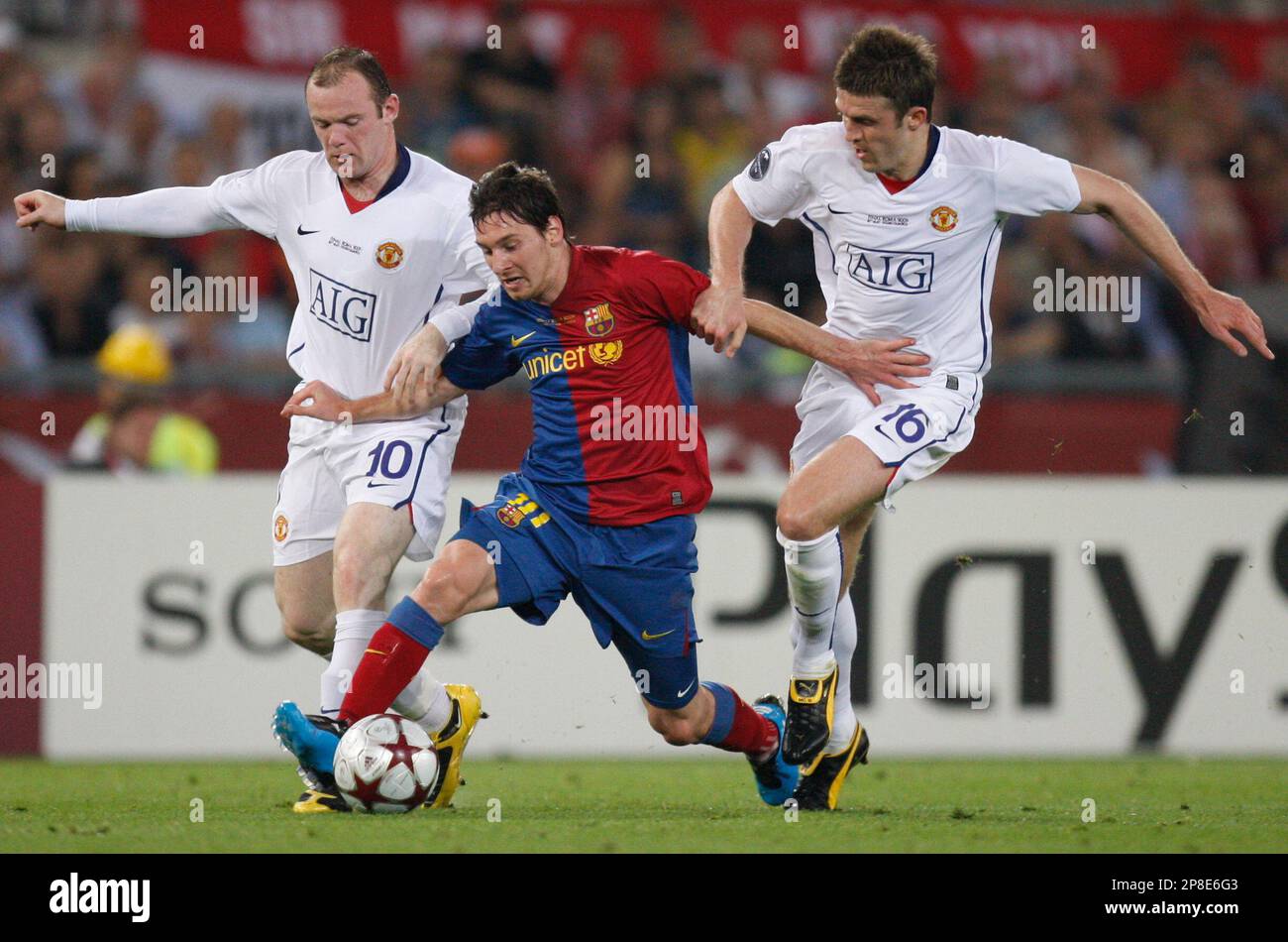 Barcelona's Lionel Messi, center, is caught between Manchester United's ...