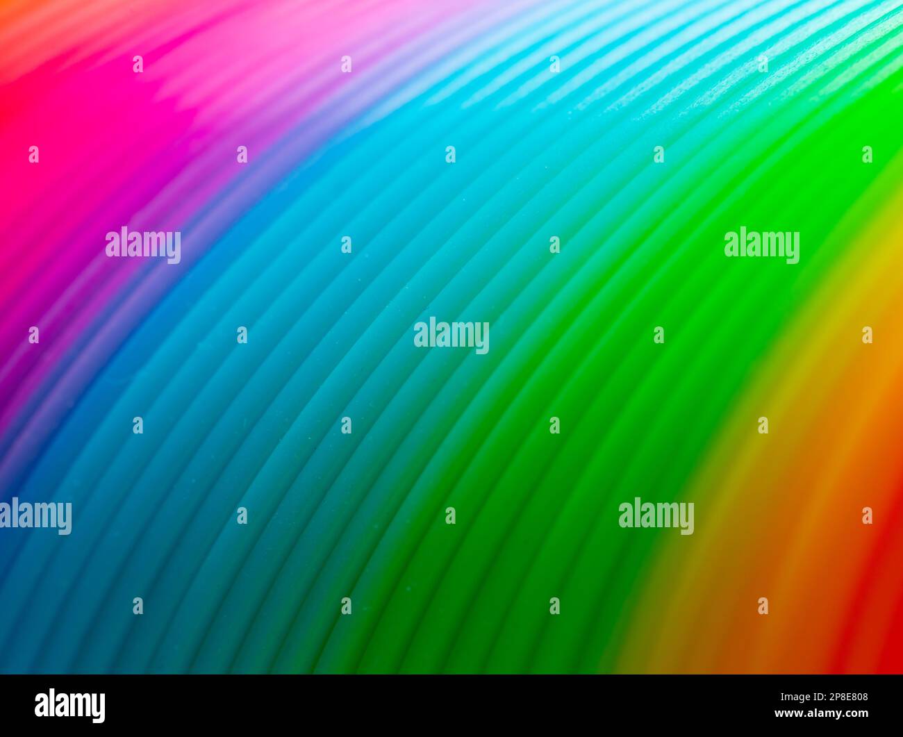 Details of a rainbow coloured plastic toy Stock Photo - Alamy