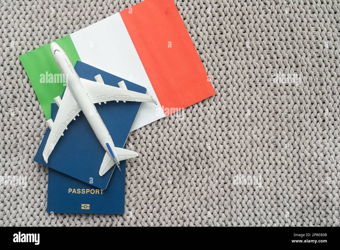 Travel flight to Italy concept. Toy airplane model with passport and ...