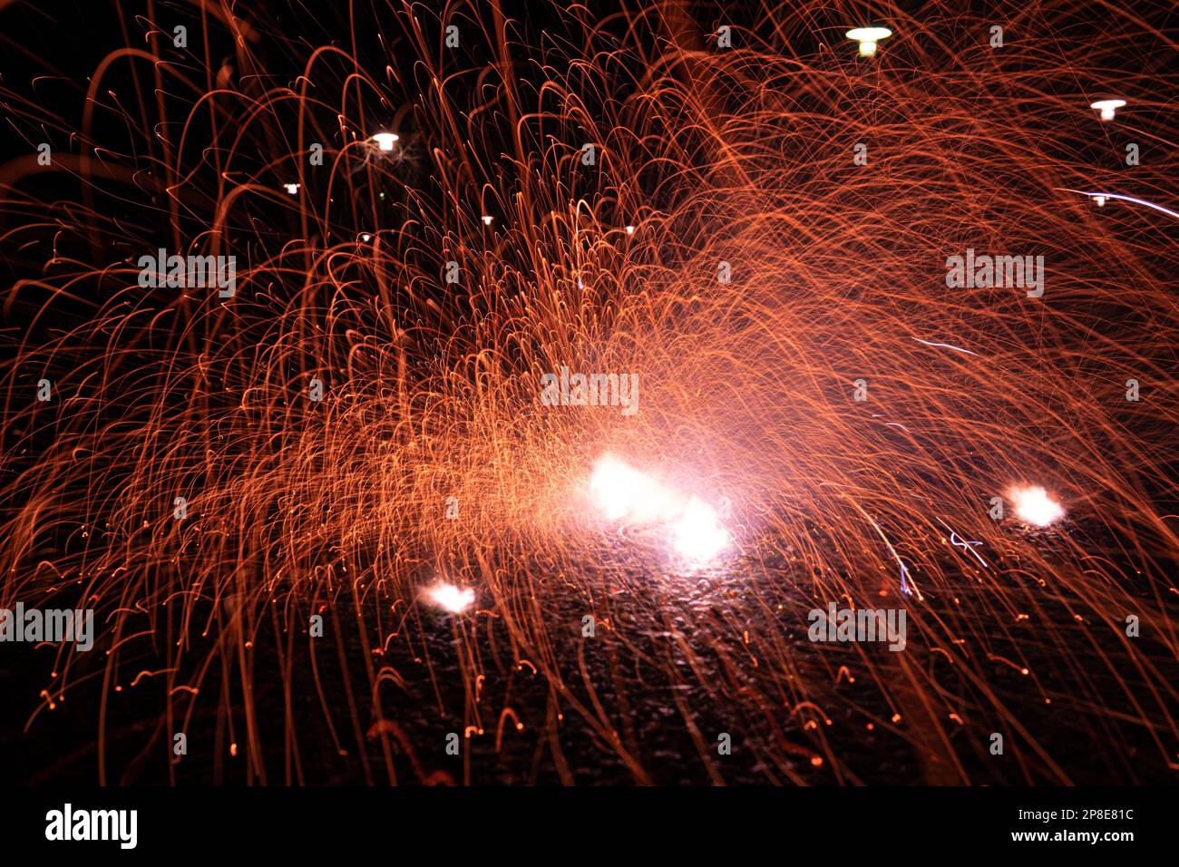 Yellow ground fireworks on asphalt exploding Stock Photo - Alamy