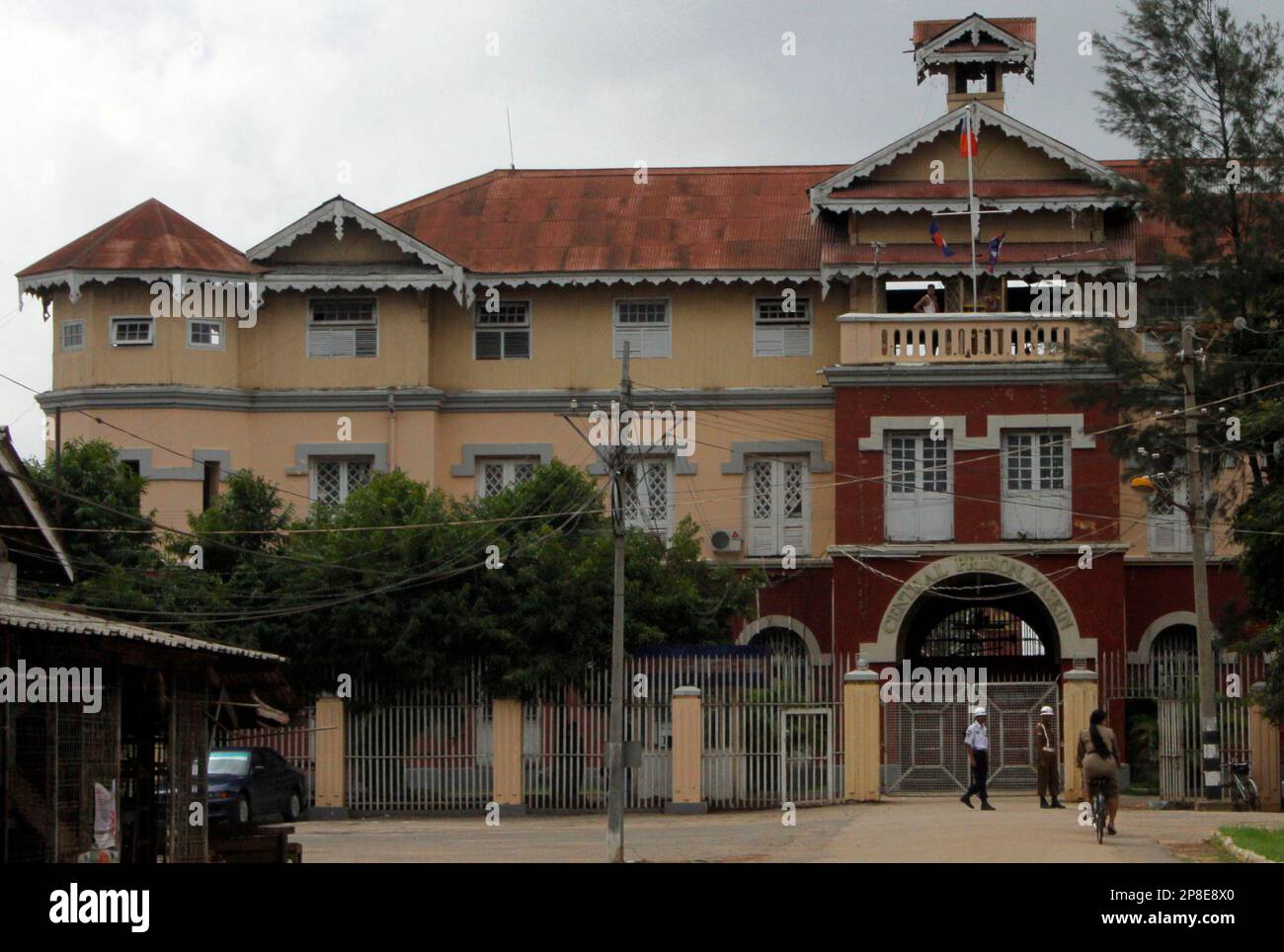 Traffic officers stand near a large building at the main gate of ...