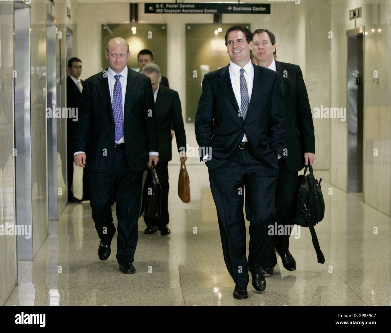 Dallas Mavericks owner Mark Cuban, front, walks out of his hearing with ...