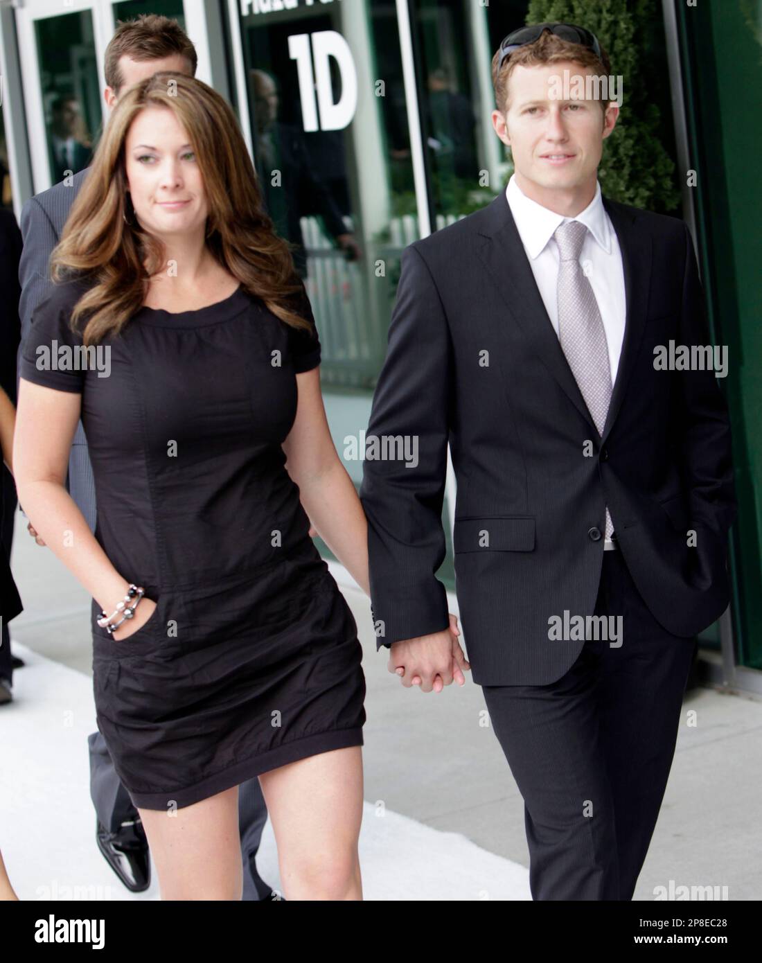 Ryan Briscoe, right, of Australia, right, arrives with fiancee, Nicole ...