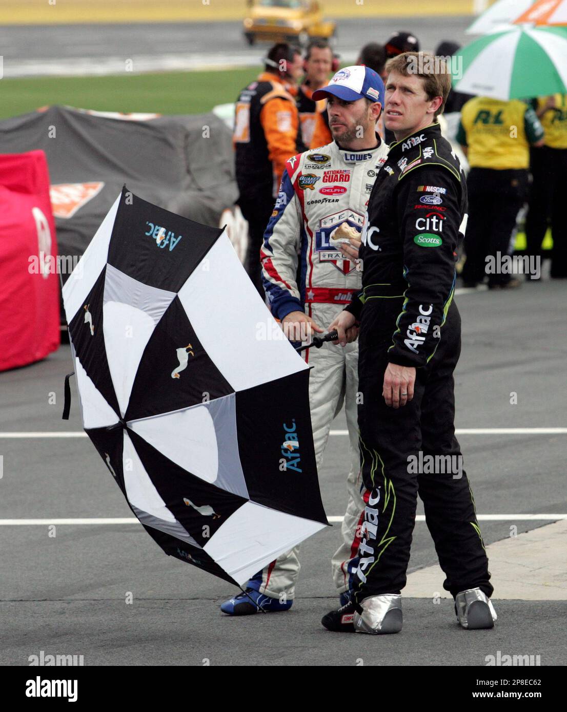 Carl Edwards, right, and Jimmie Johnson, left, look out from pit road ...