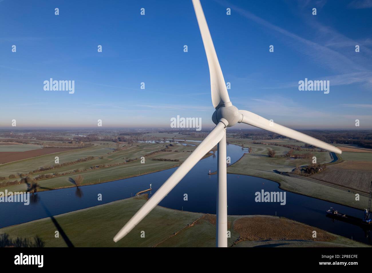 Contrasting closeup of wind turbine and against clear blue sky in The ...