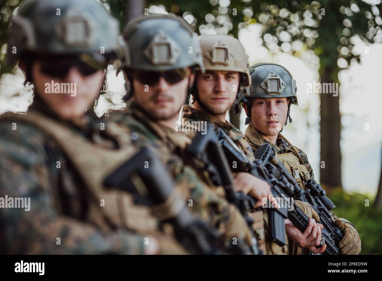 Soldier fighters standing together with guns. Group portrait of US army ...