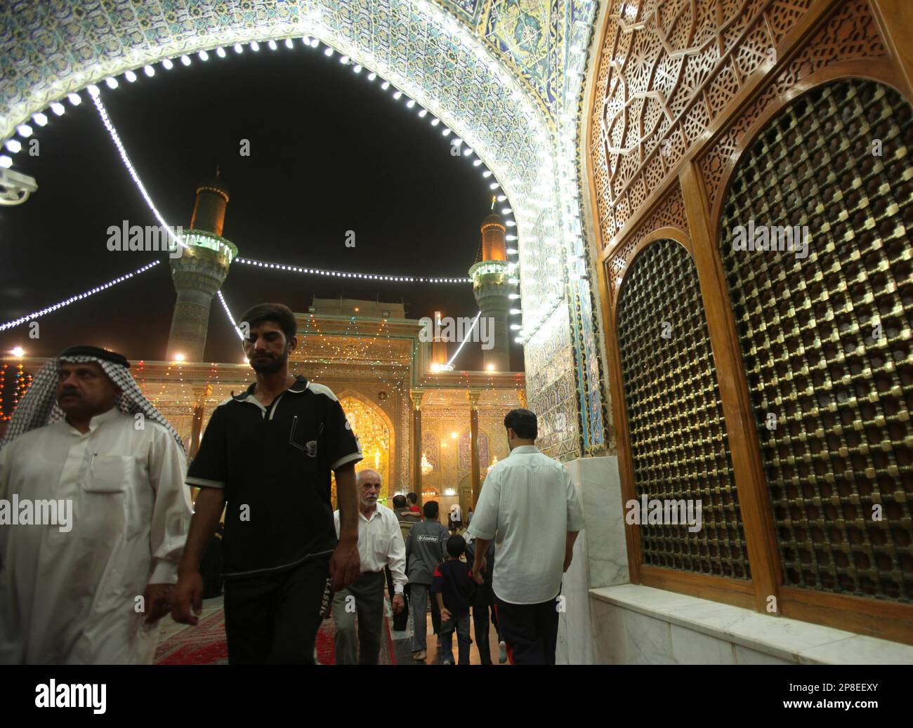 Pilgrims walk inside the holy Shiite shrine of Imam Kazim in Kazimiyah ...