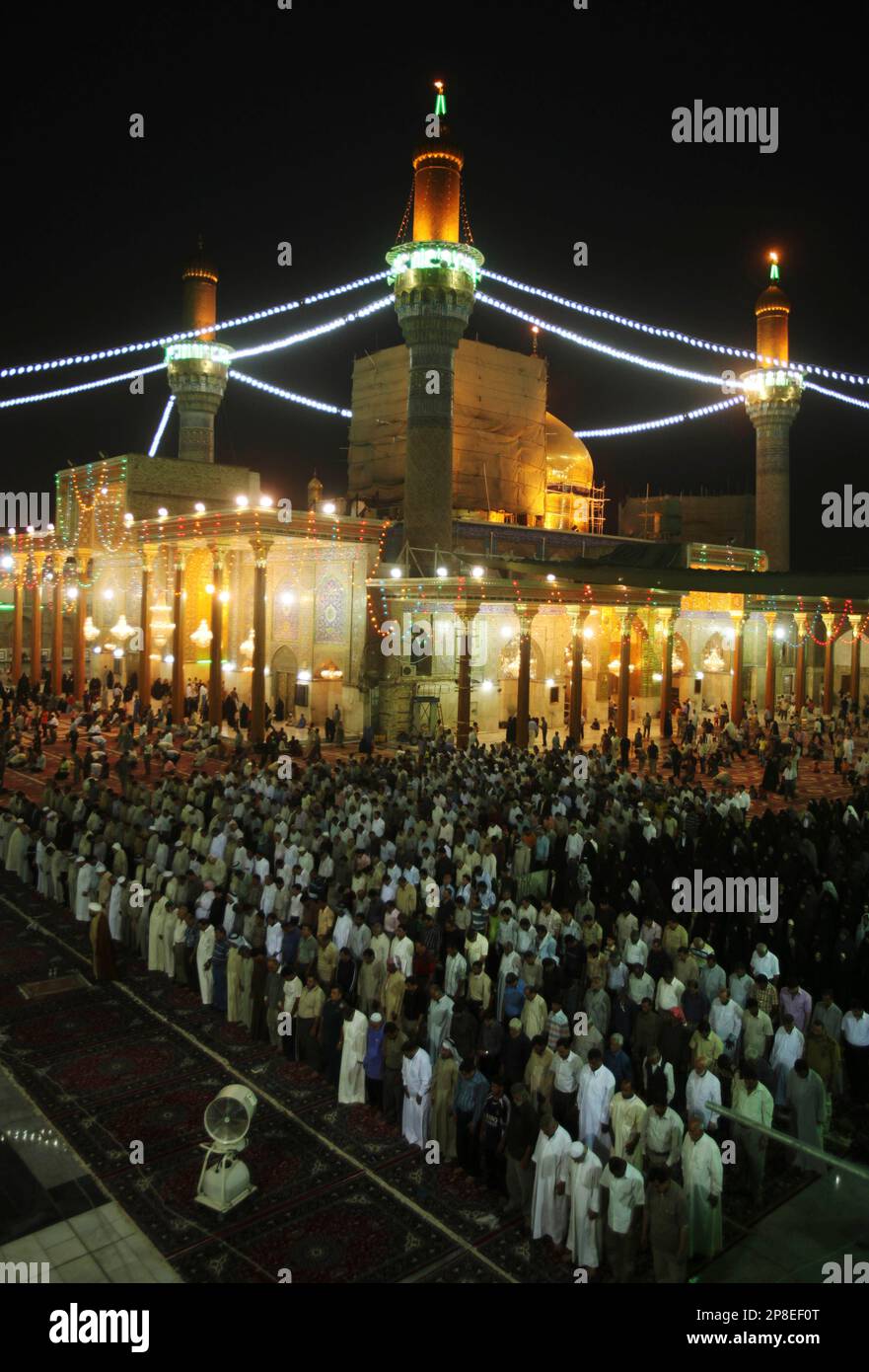 Pilgrims pray inside the holy Shiite shrine of Imam Kazim in Kazimiyah ...