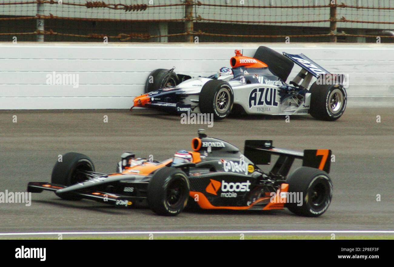 Mario Moraes, top, of Brazil, hits the wall on the first lap as Danica ...