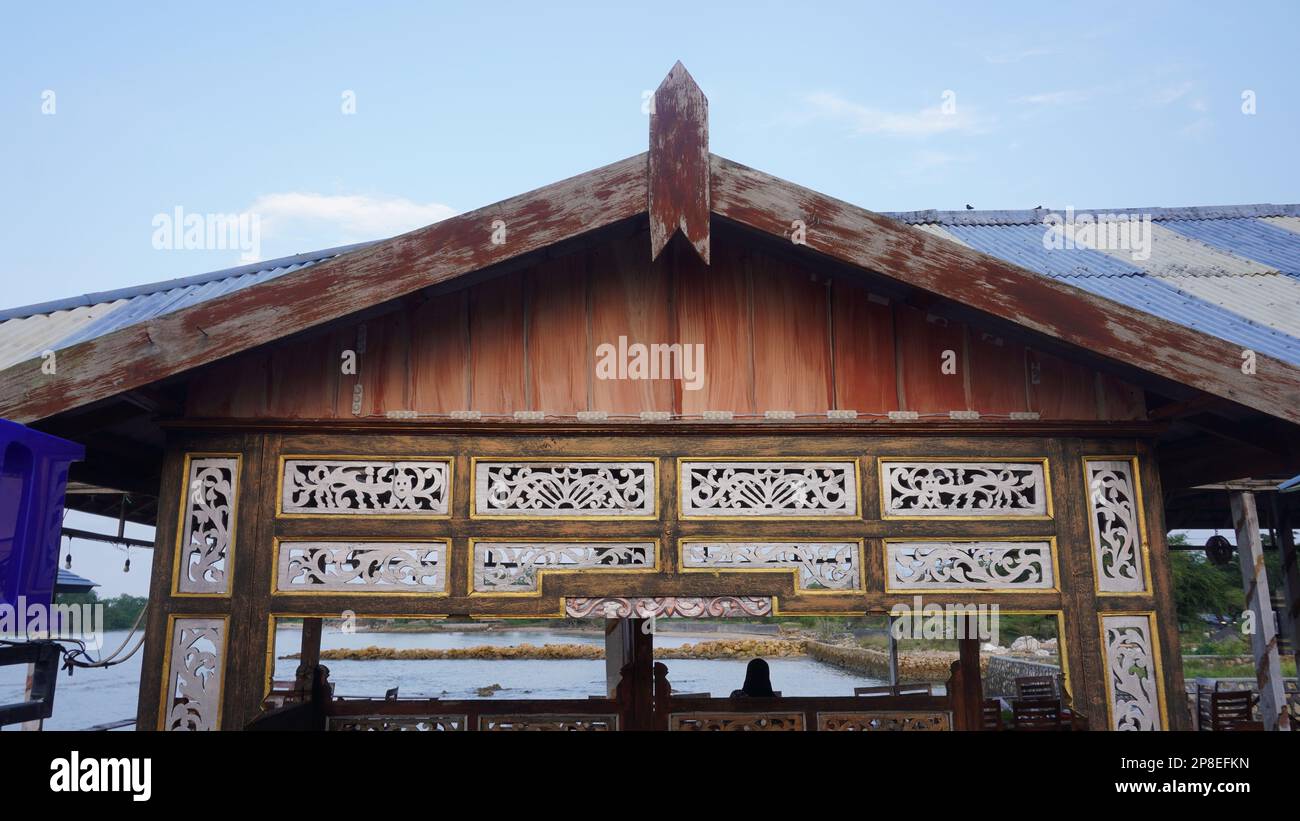 wood carving on the roof of a traditional Javanese house Stock Photo ...