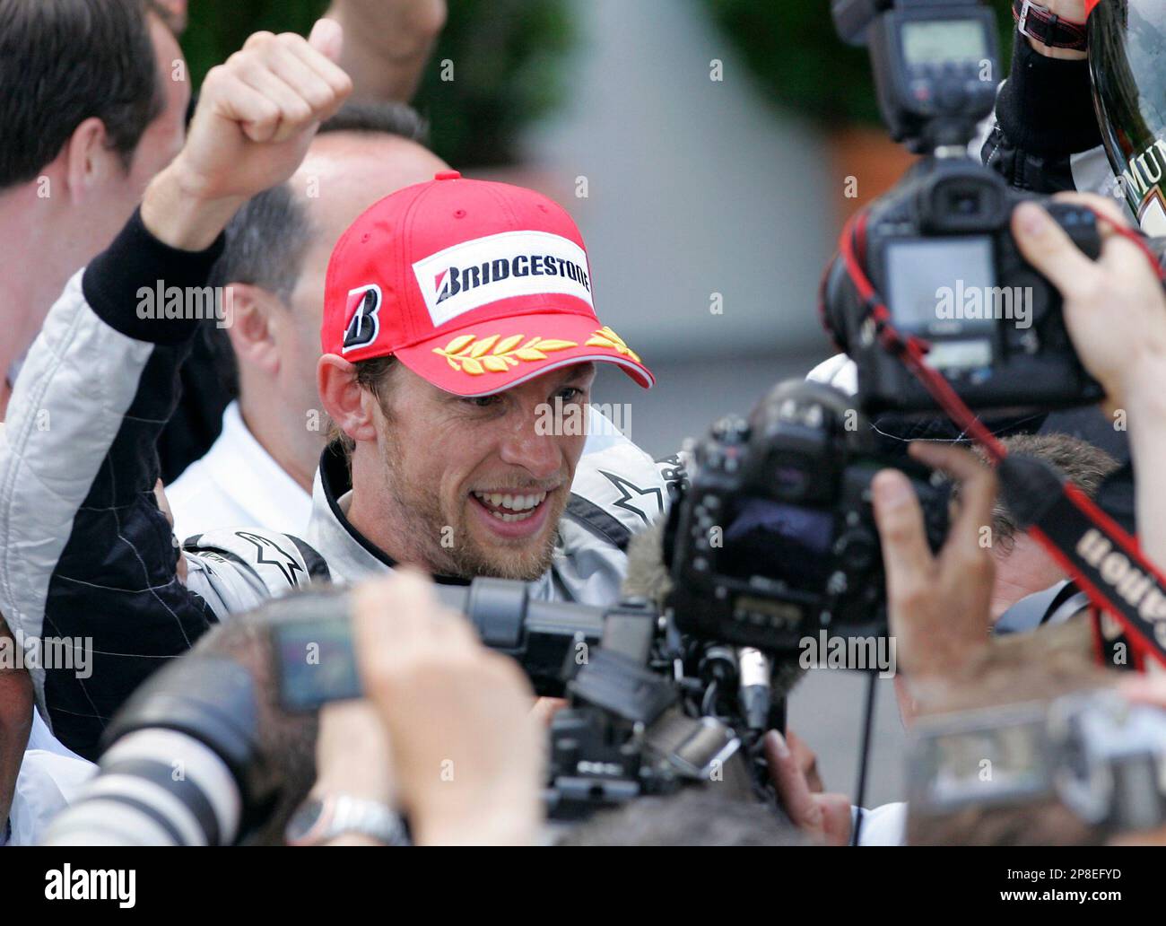 Brawn GP driver Jenson Button of Britain celebrates after winning the ...