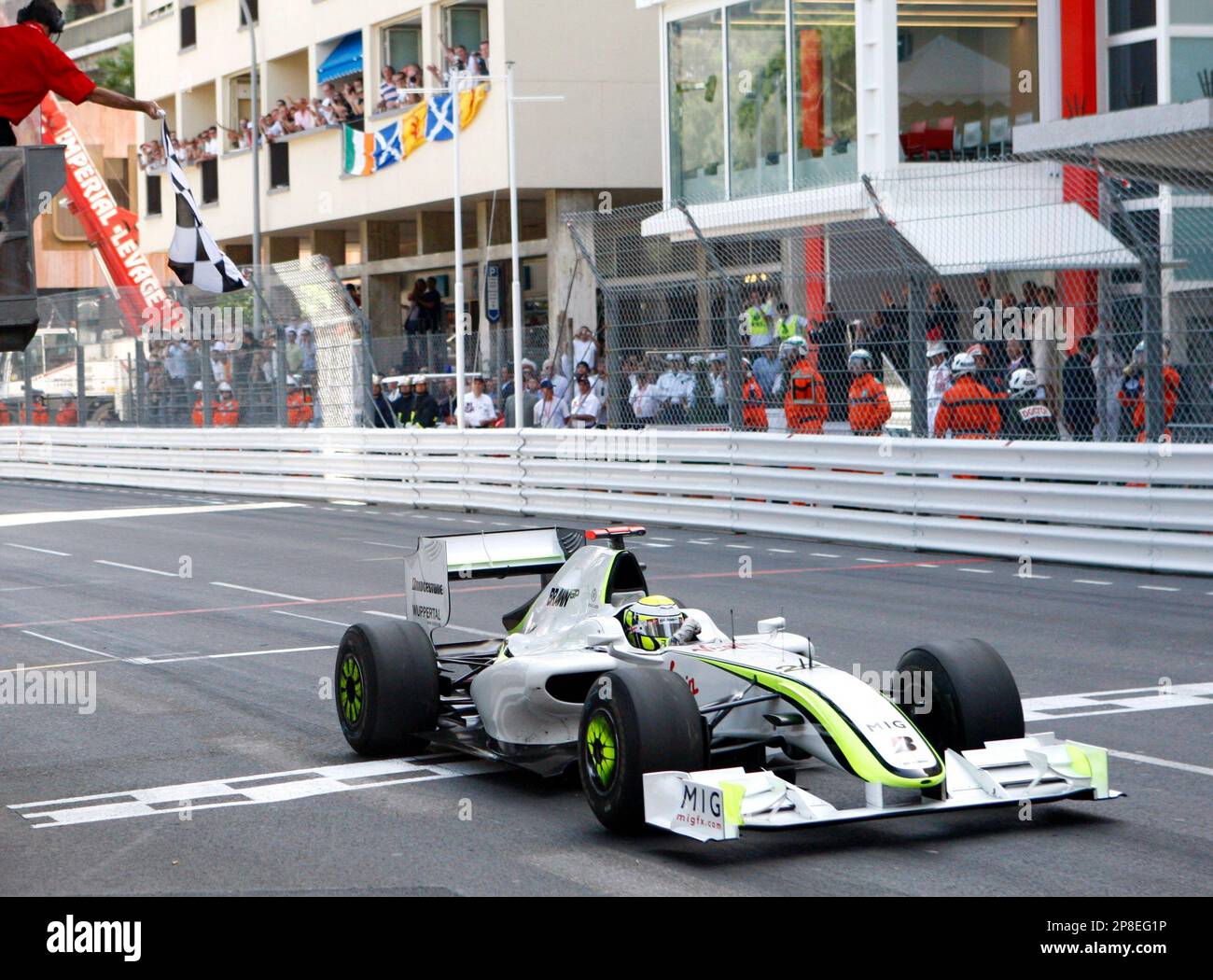 Brawn GP driver Jenson Button of Britain gets the checkered flag as he ...