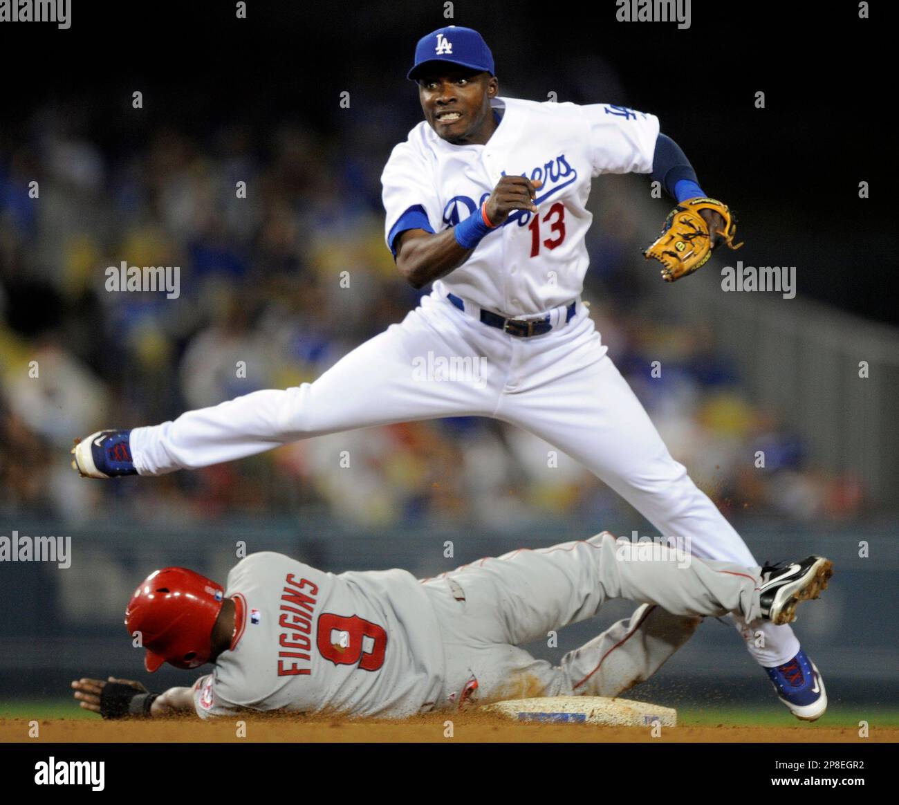 Los Angeles Angels' Chone Figgins, bottom, breaks up a double play with ...