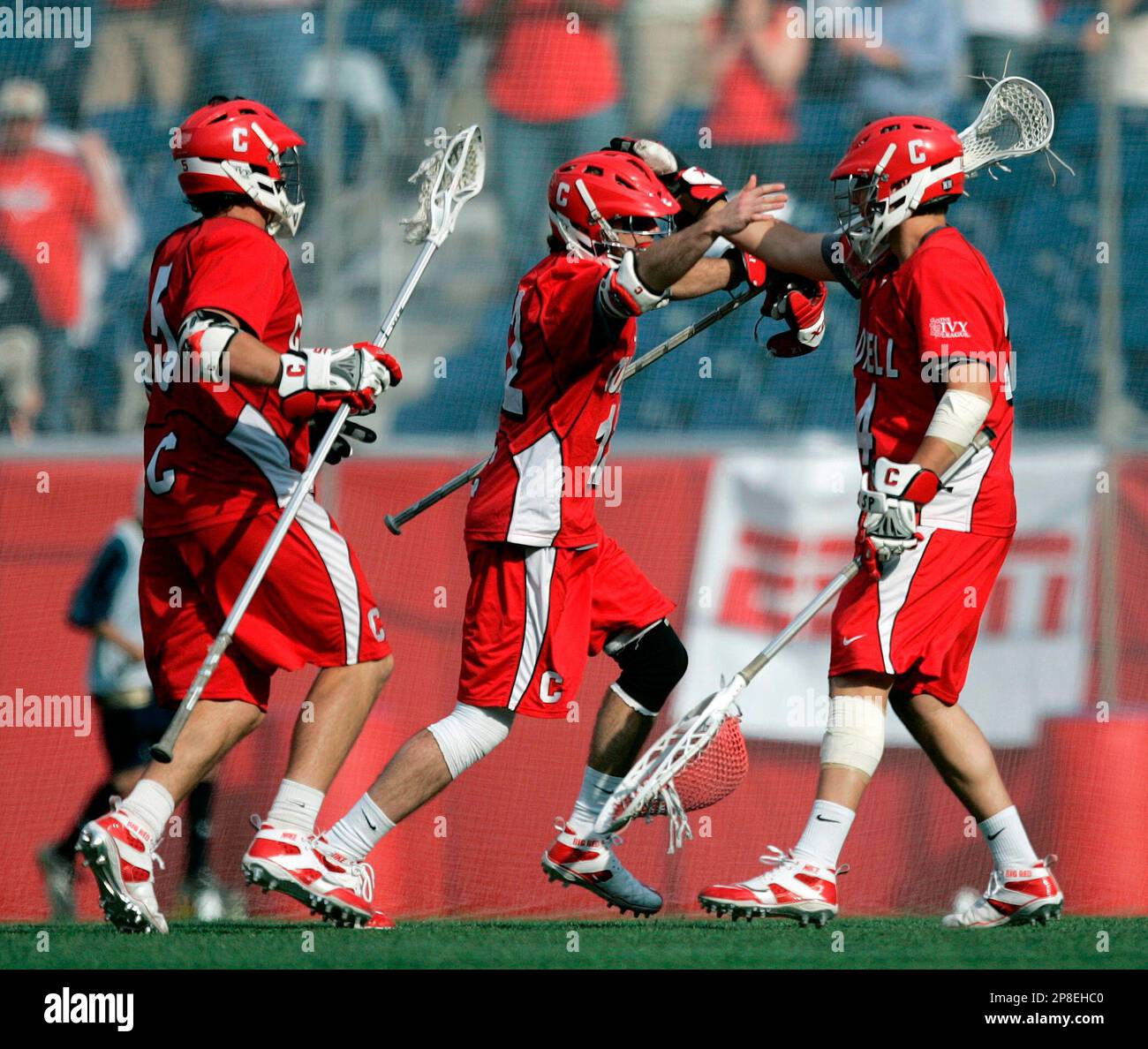 Cornell's Matt Moyer, center, and Pierce Derkac, left, celebrate with ...