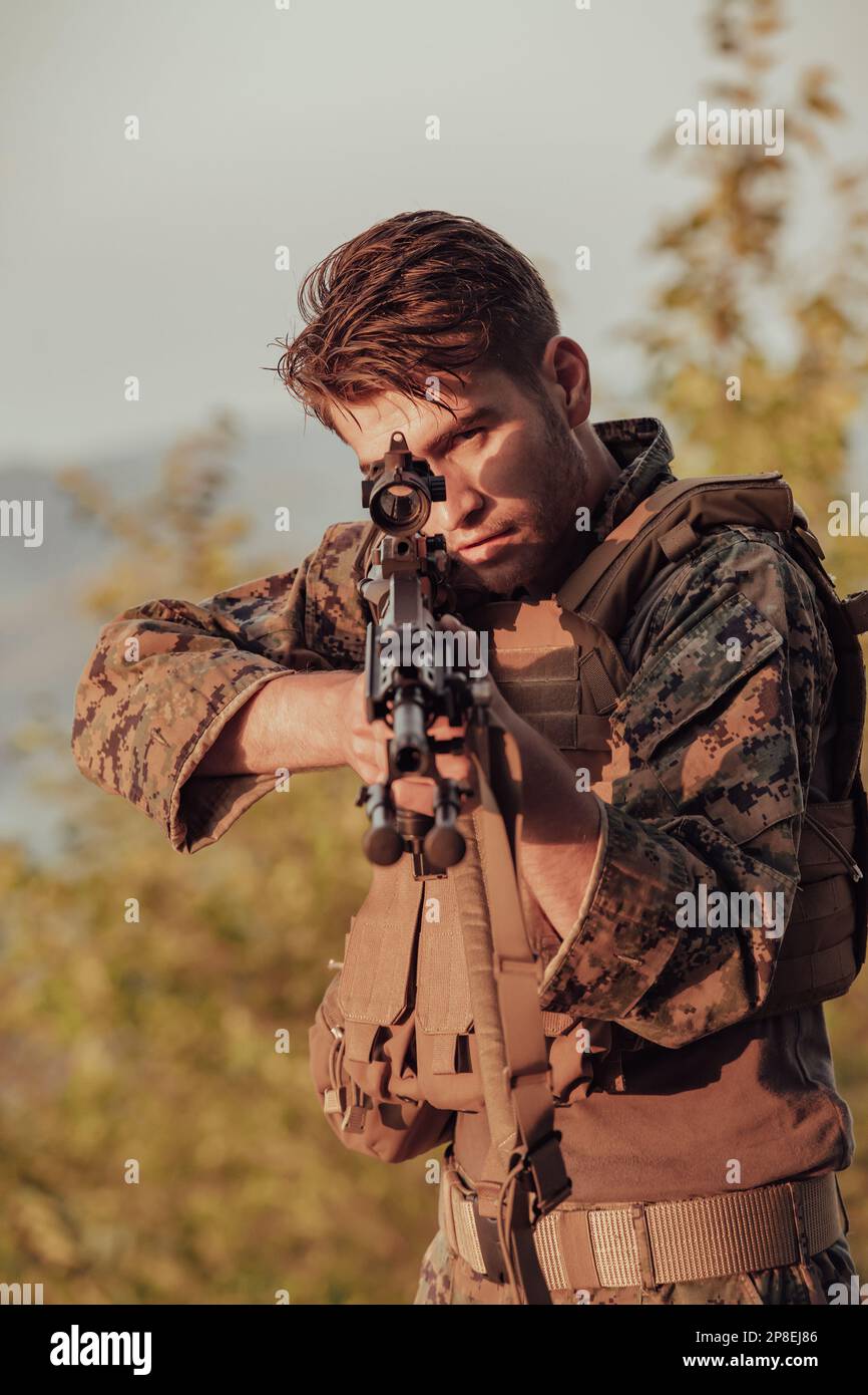 A modern warfare soldier on war duty in dense and dangerous forest ...