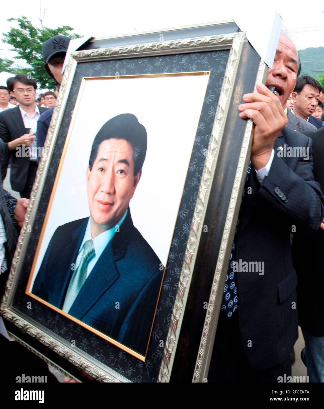 A portrait of former President Roh Moo-hyun is carried for Roh's ...