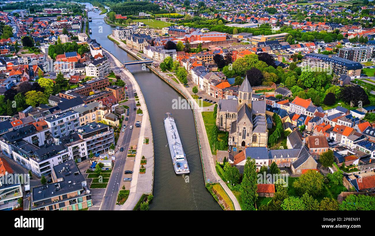 Cargo boat passing through the city of Oudenaarde on the Schelde river ...