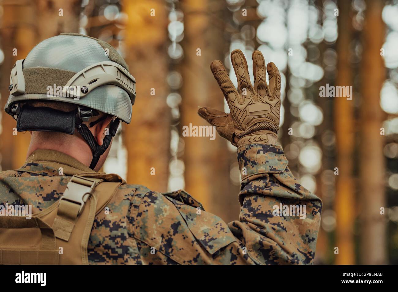 Modern warfare soldier officer is showing tactical hand signals to ...