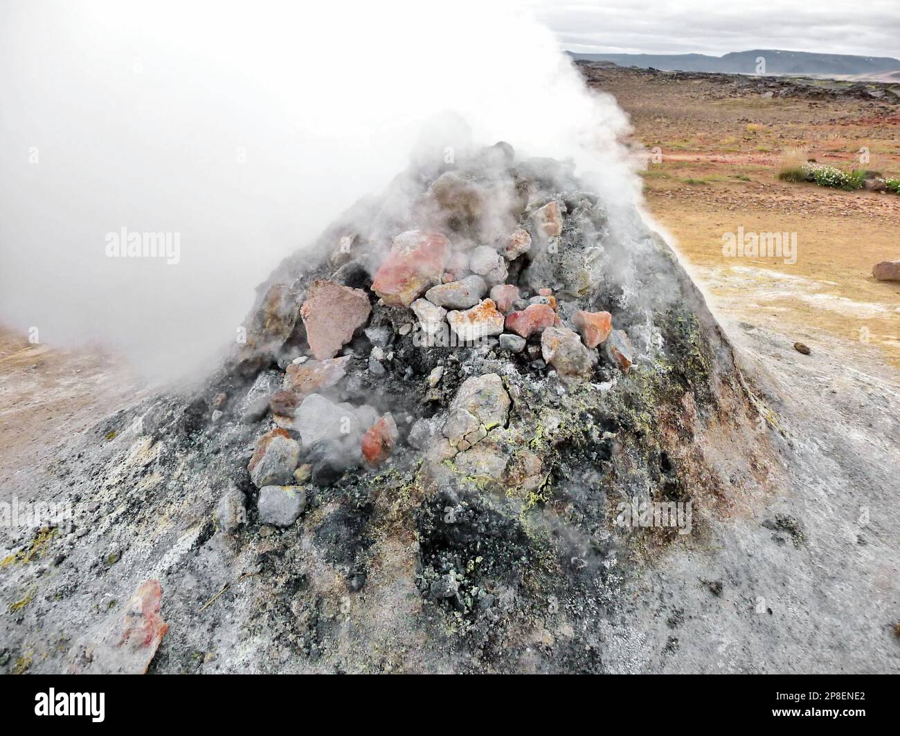 Close-up of steam coming out of a geothermal fumarole in summer ...