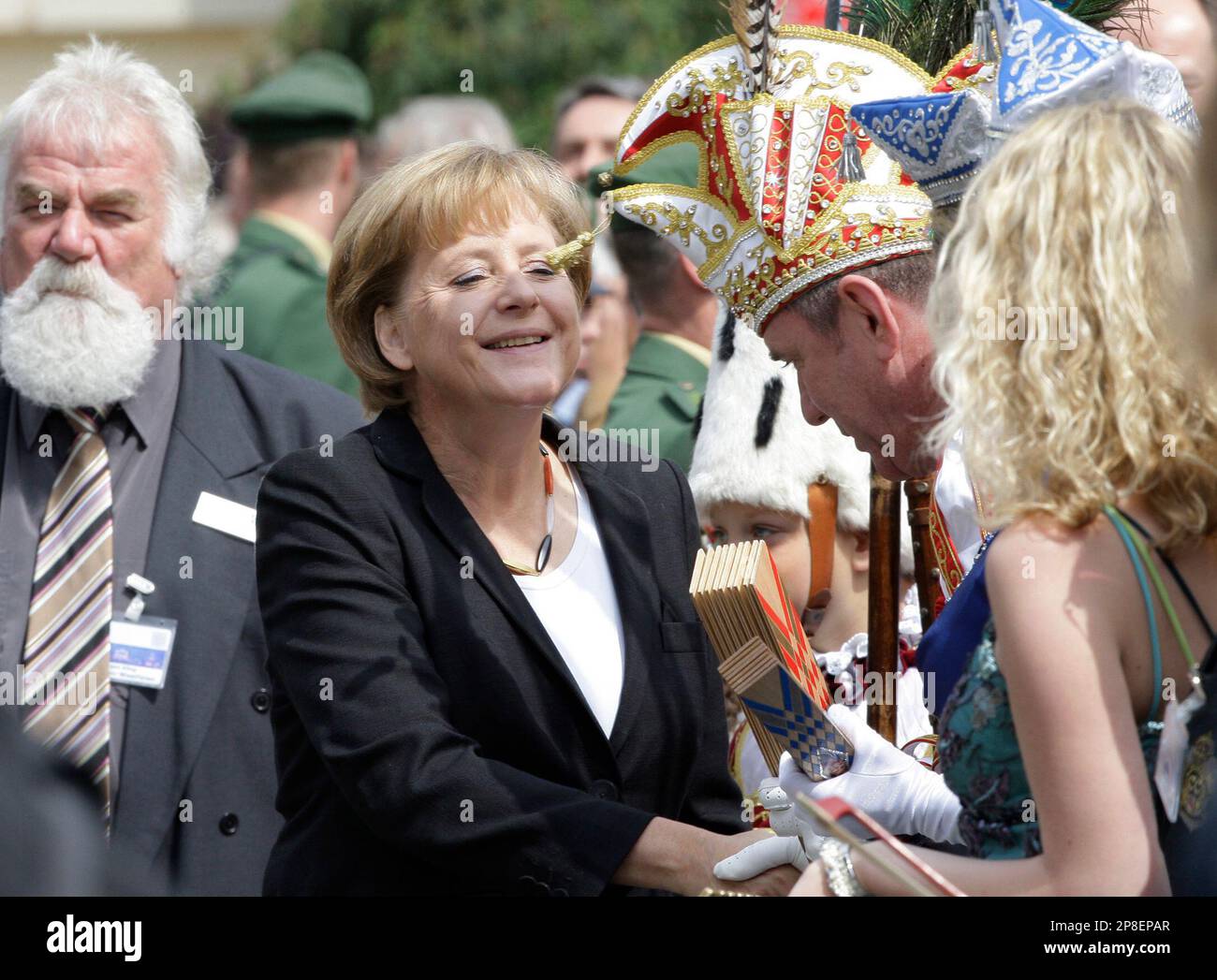 German Chancellor Angela Merkel welcomes revelers during a celebration ...