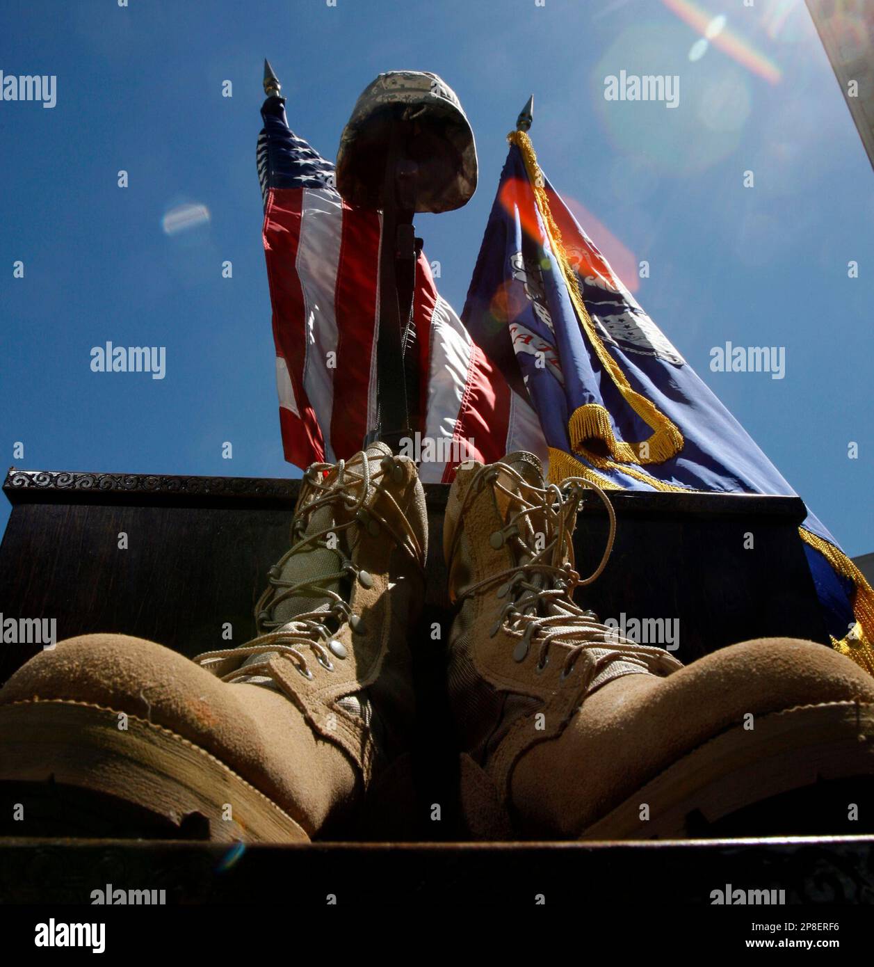 Boots, rifle, helmet and flags are seen at Capitol Square in Richmond ...