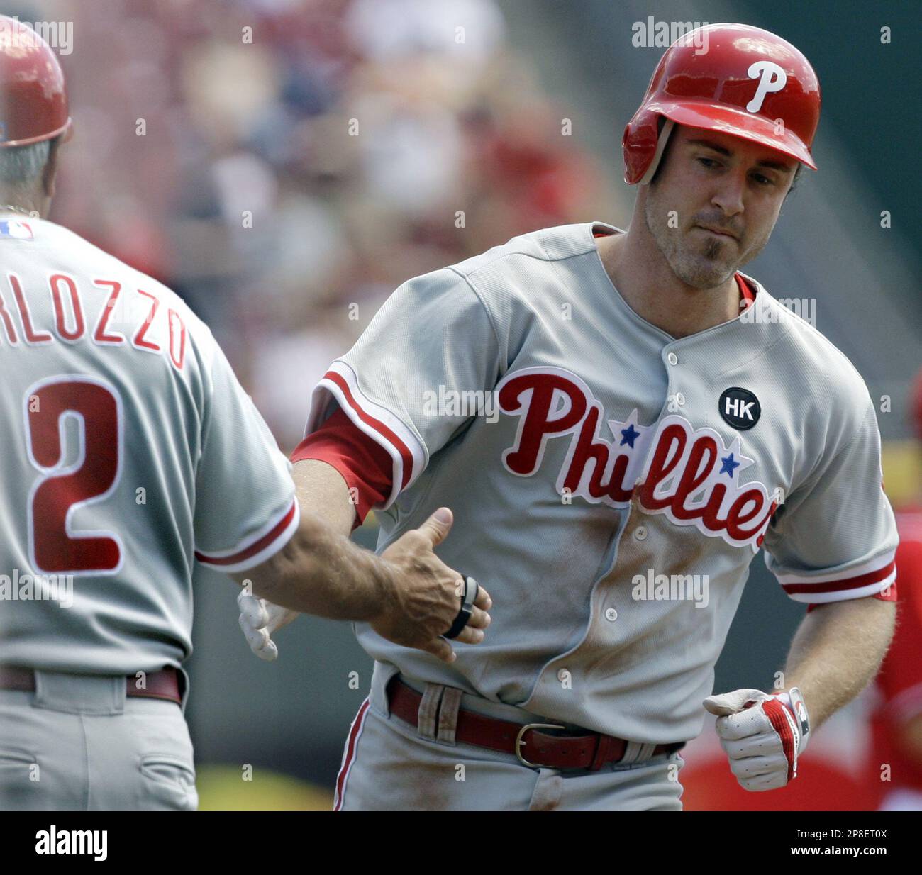 Philadelphia Phillies' Chase Utley is congratulated by third base coach ...