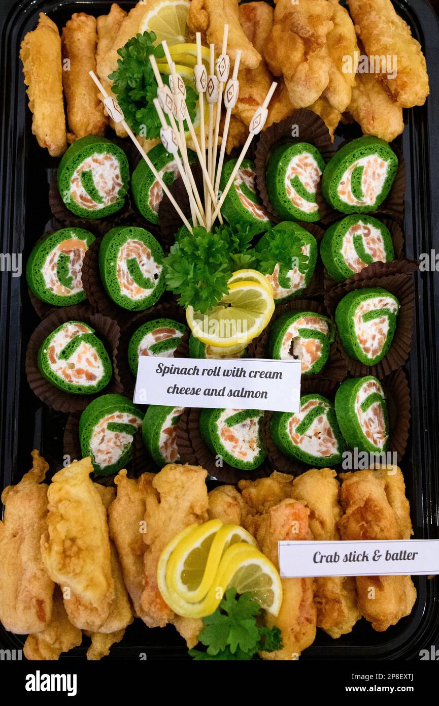 Overhead view of spinach rolls with cream cheese and salmon, and crab ...