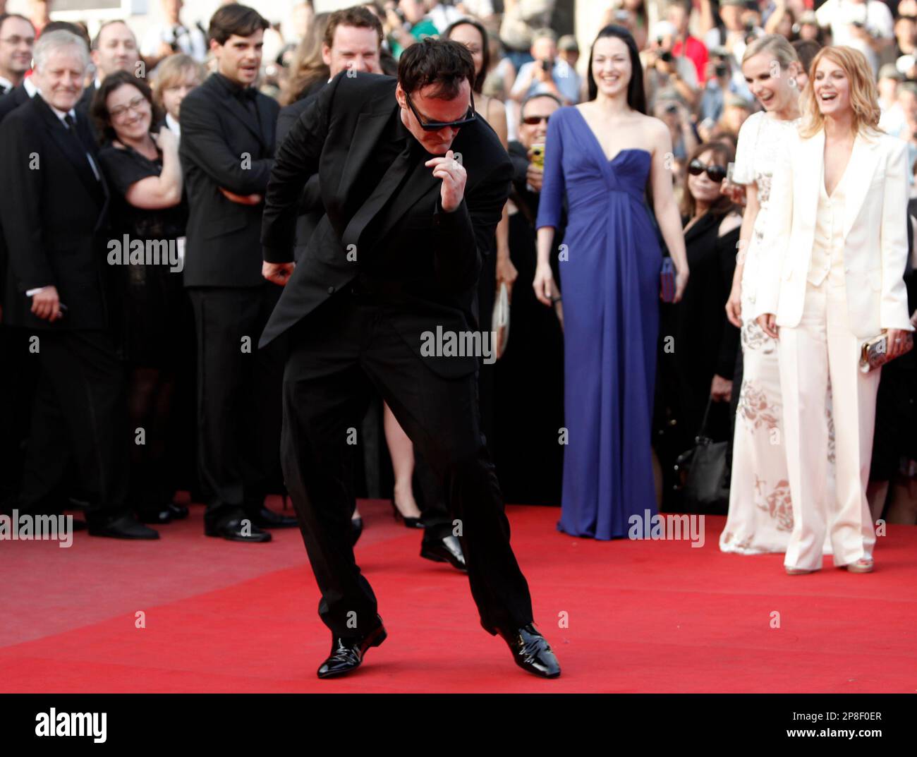 American director Quentin Tarantino, center, dances as he arrives on ...