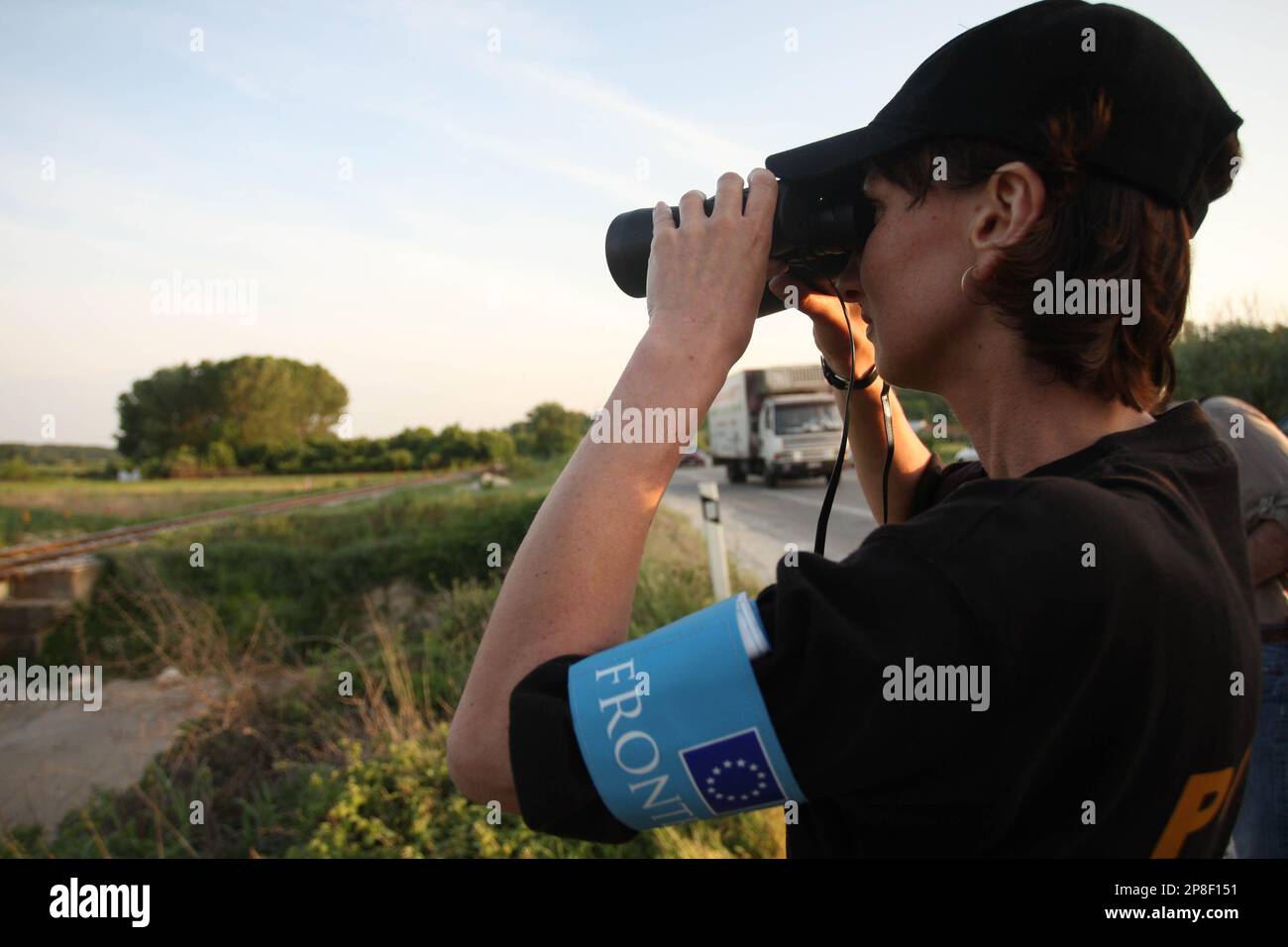 In this Tuesday, May 19, 2009 photo, a border guard peers through ...