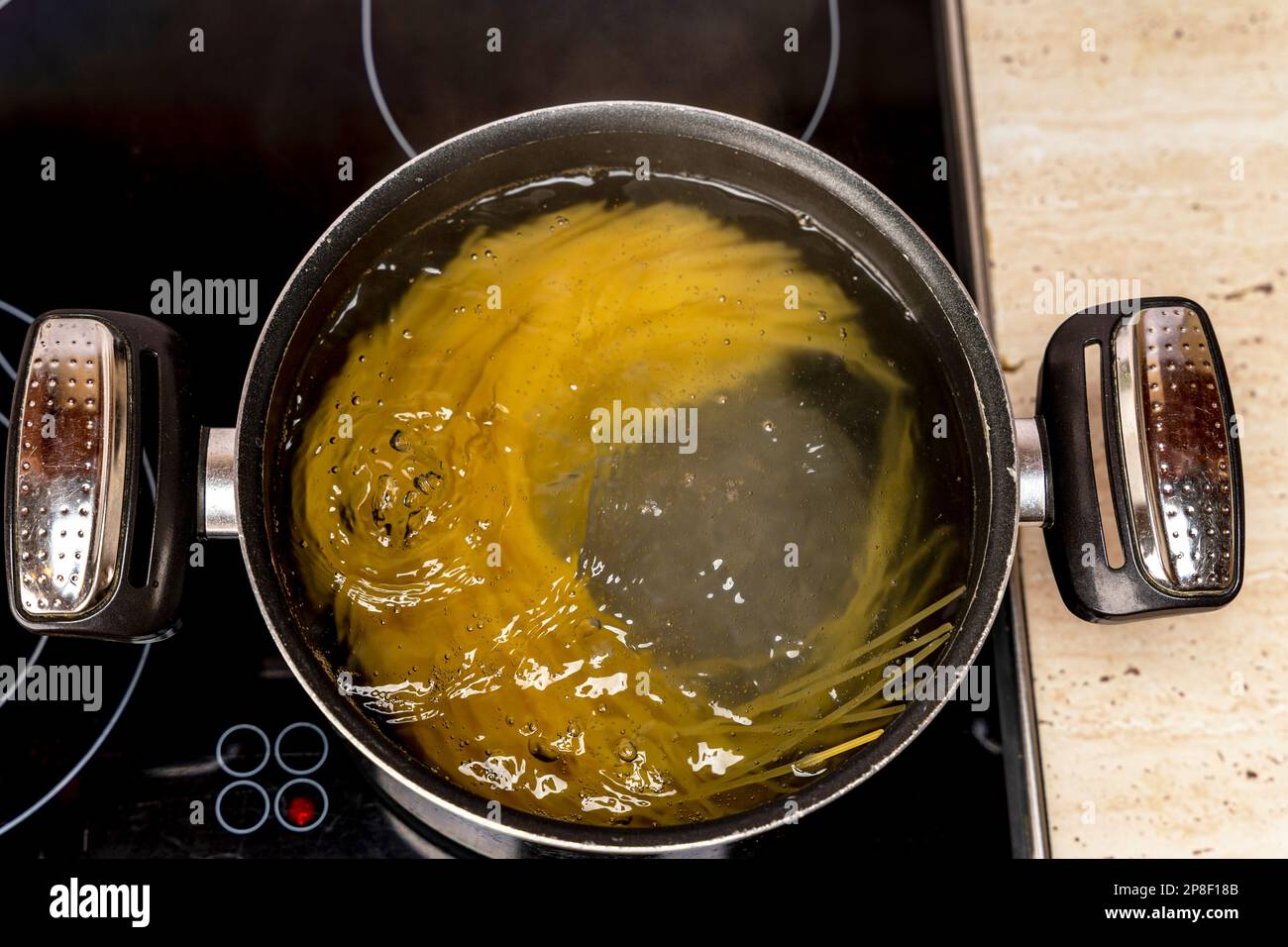 Cooking delicious spaghetti in boiling water Stock Photo - Alamy
