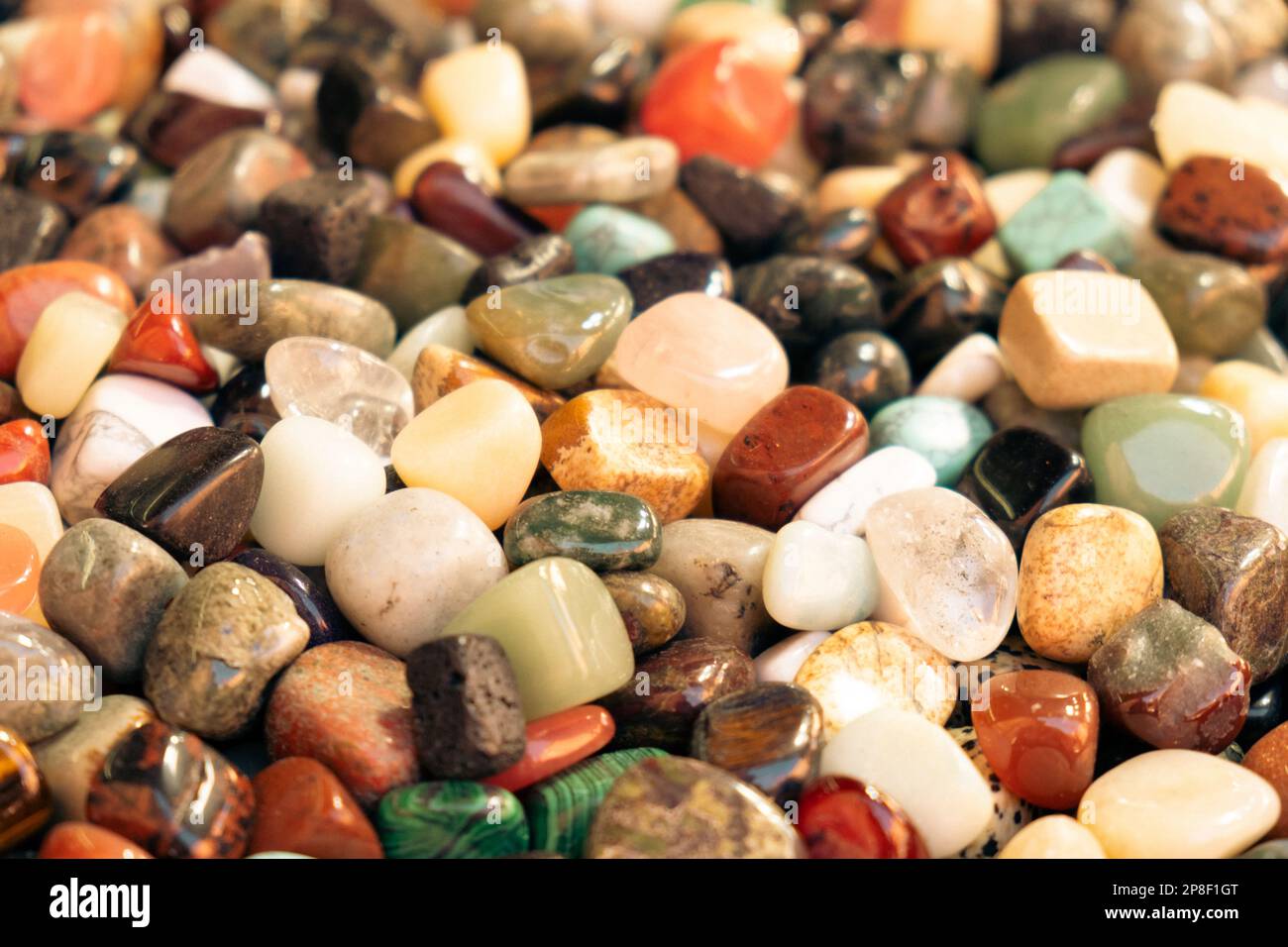 Polished and rounded pieces of gemstones due to erosion Stock Photo - Alamy