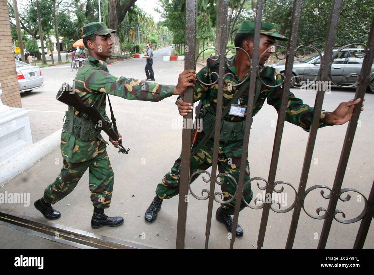 Bangladesh Army guards pull the main gate open at the Bangladesh Rifles ...