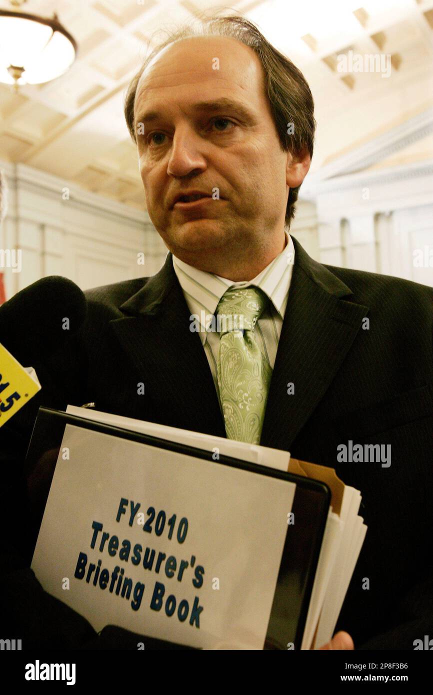 New Jersey Treasurer David Rousseau holds his briefing book Tuesday ...