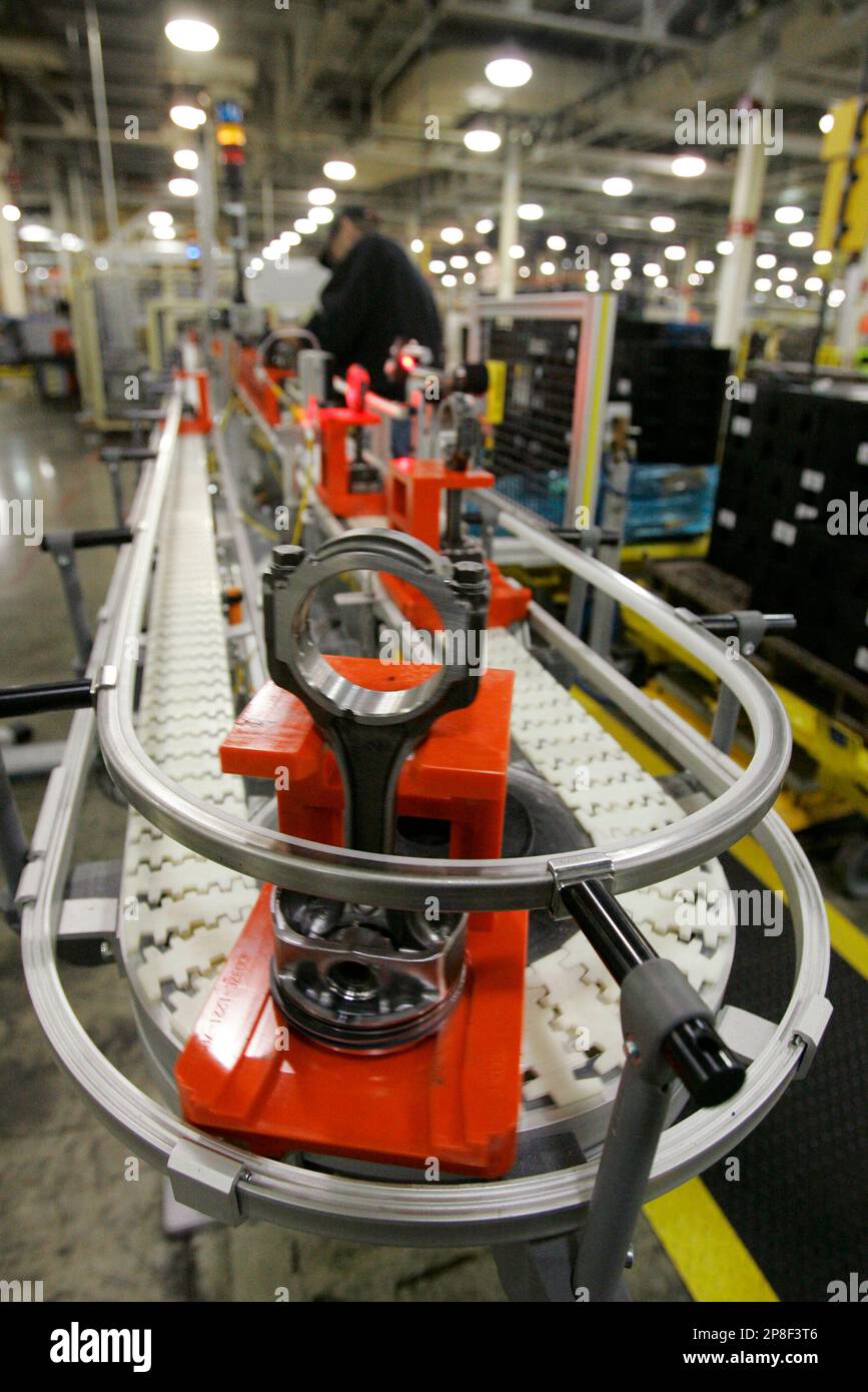 Assembled pistons for the EcoBoost V-6 engine move along a belt at Ford ...