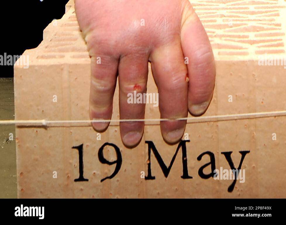 Grazes on the fingers of Britain's Prince Charles, as he lays a ...